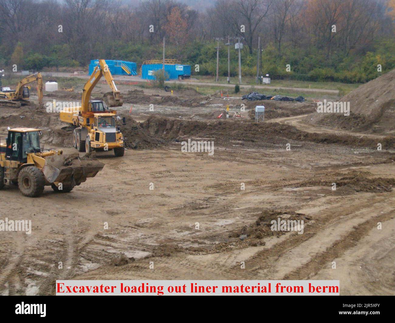 Excavater loading out liner material from berm facing Southwest ...