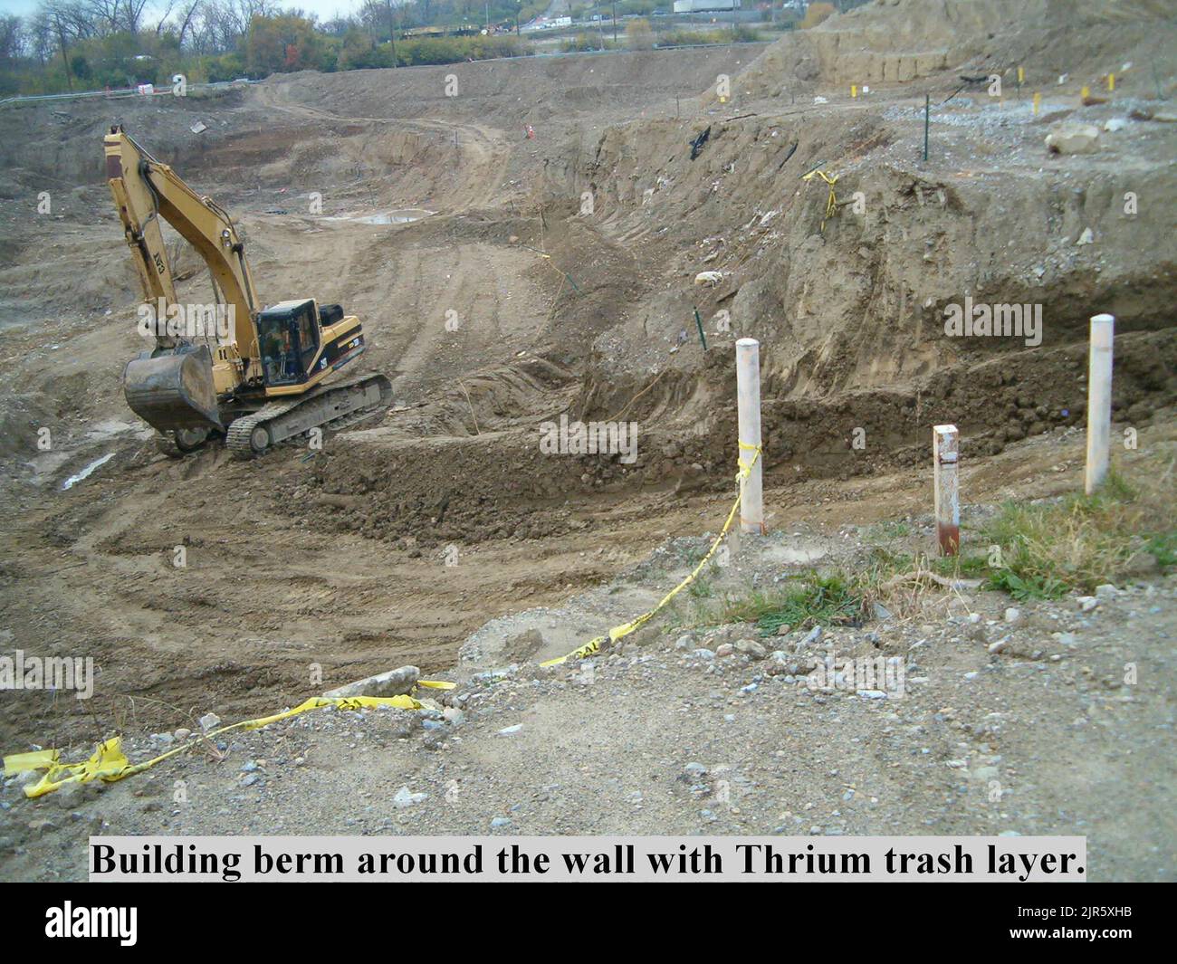 Building berm around the wall with Thorium trash layer facing North ...