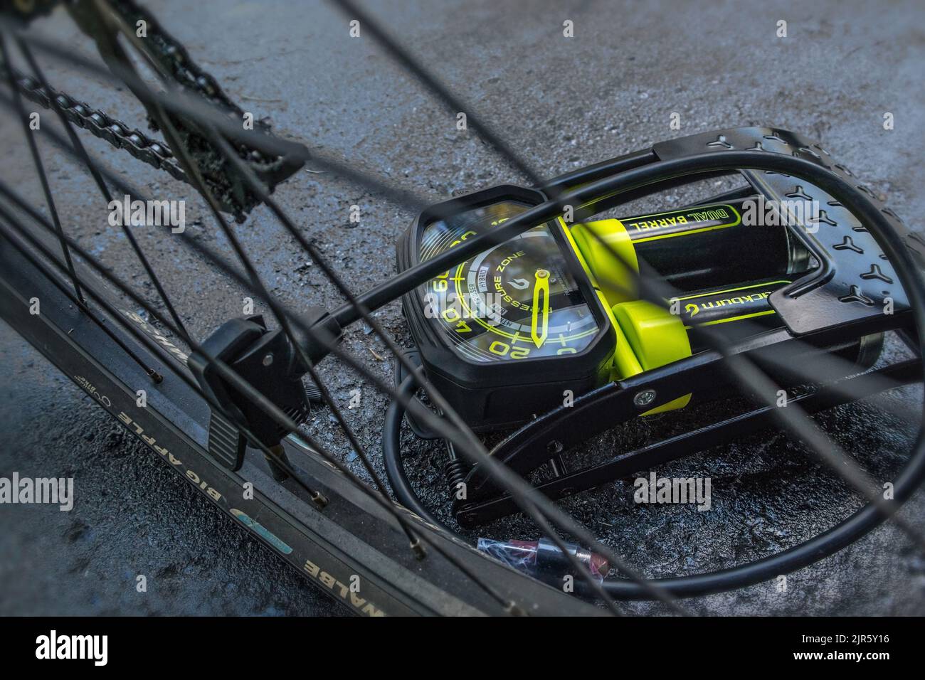 A foot pump connected to a bike tire Stock Photo - Alamy