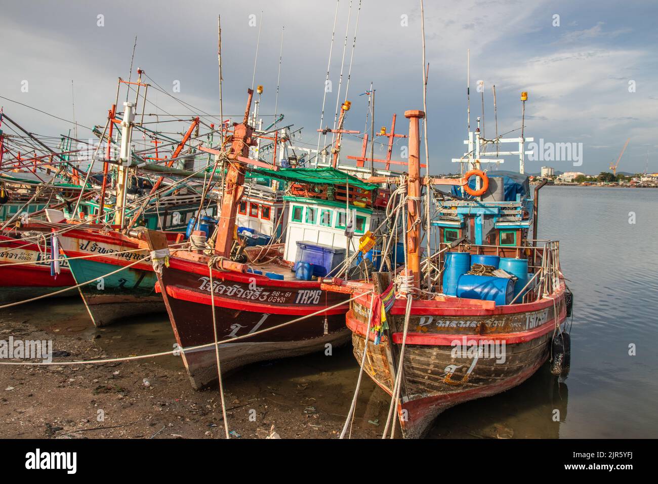 Thai fishing boats at a pier or wharf in Thailand Southeast Asia Stock Photo - Alamy