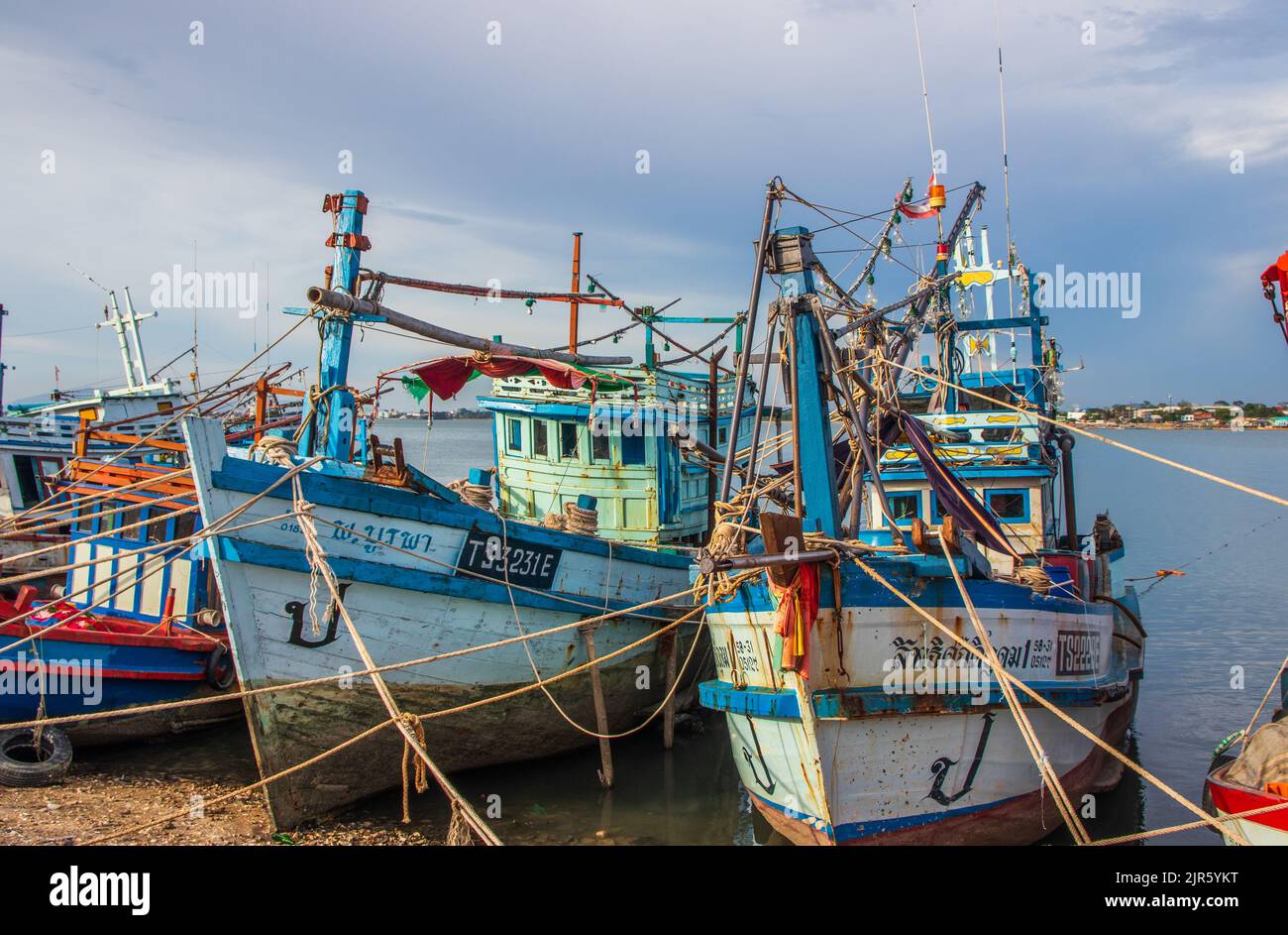 Thai fishing boats at a pier or wharf in Thailand Southeast Asia Stock Photo - Alamy