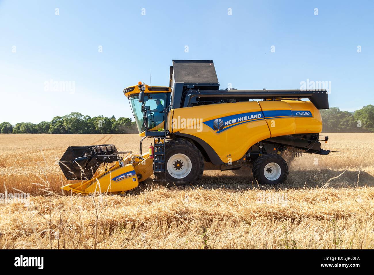 Combine Harvesting Crop in Scotland Stock Photo - Alamy