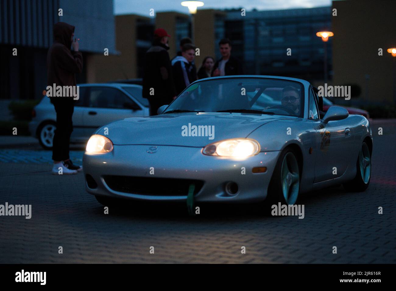 A Car meet Mazda Miata MX-5 MB with headlights on arriving in the ...