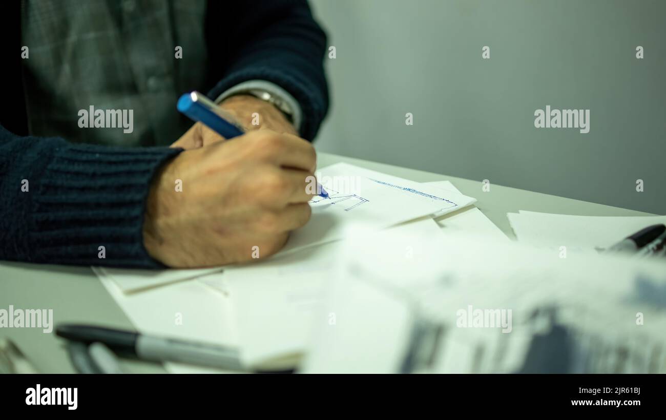 person drawing by hand with pen, pencil and ink, architectural ...