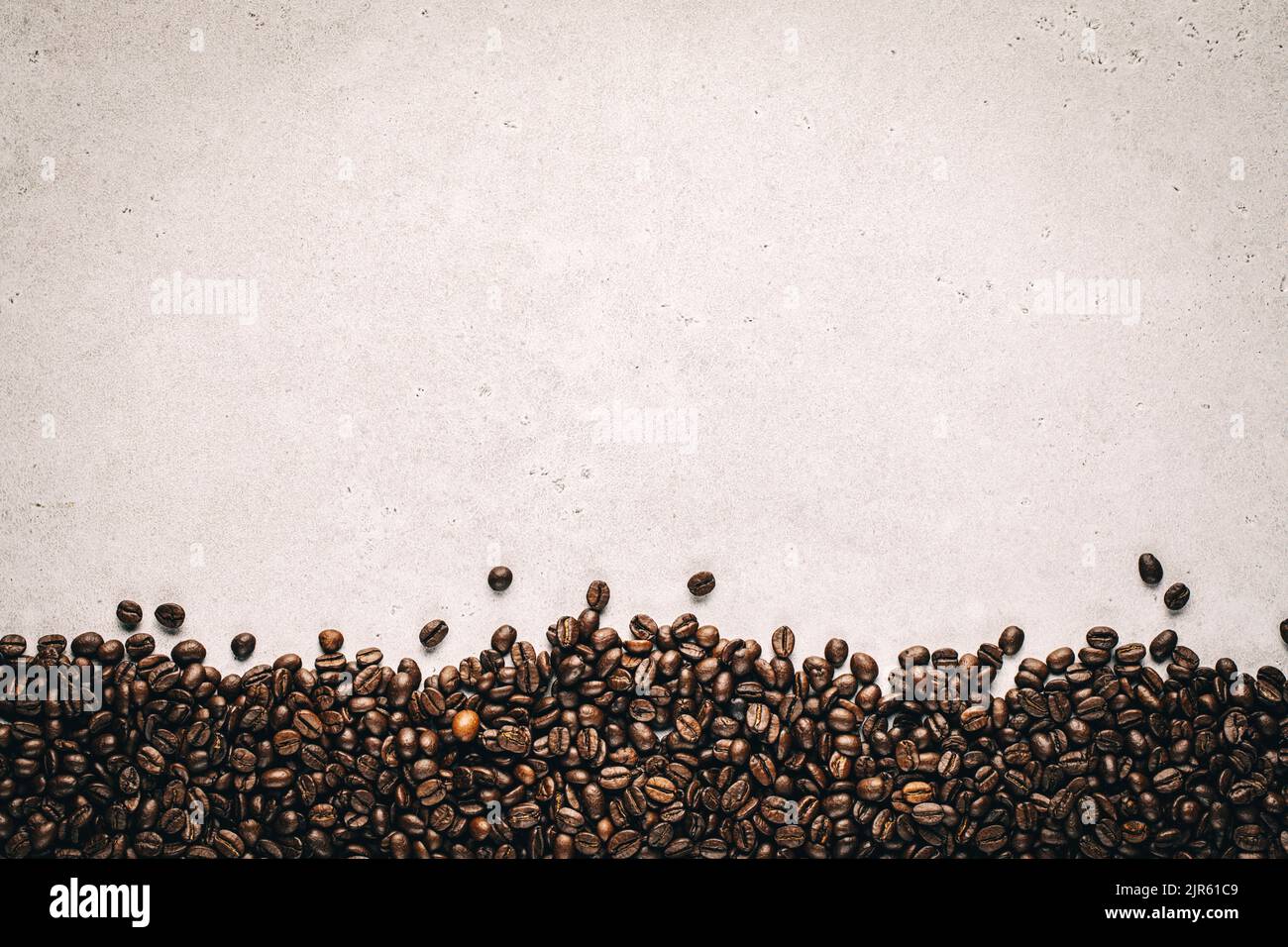 Fresh roasted coffee beans border on rough light background Stock Photo ...
