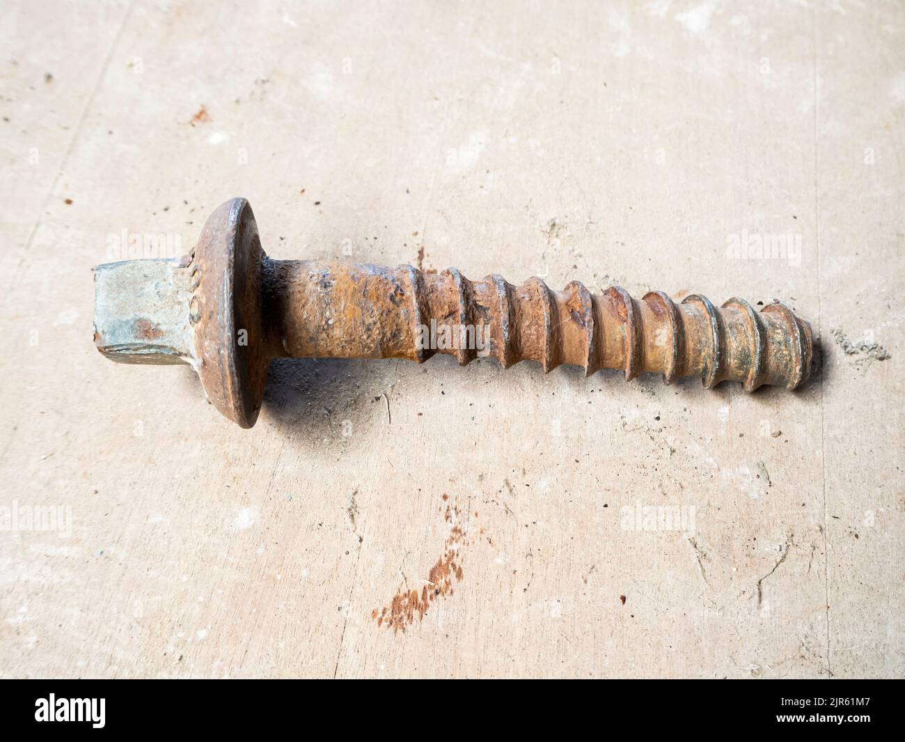 bolt rail bent on an antique wood background Stock Photo - Alamy