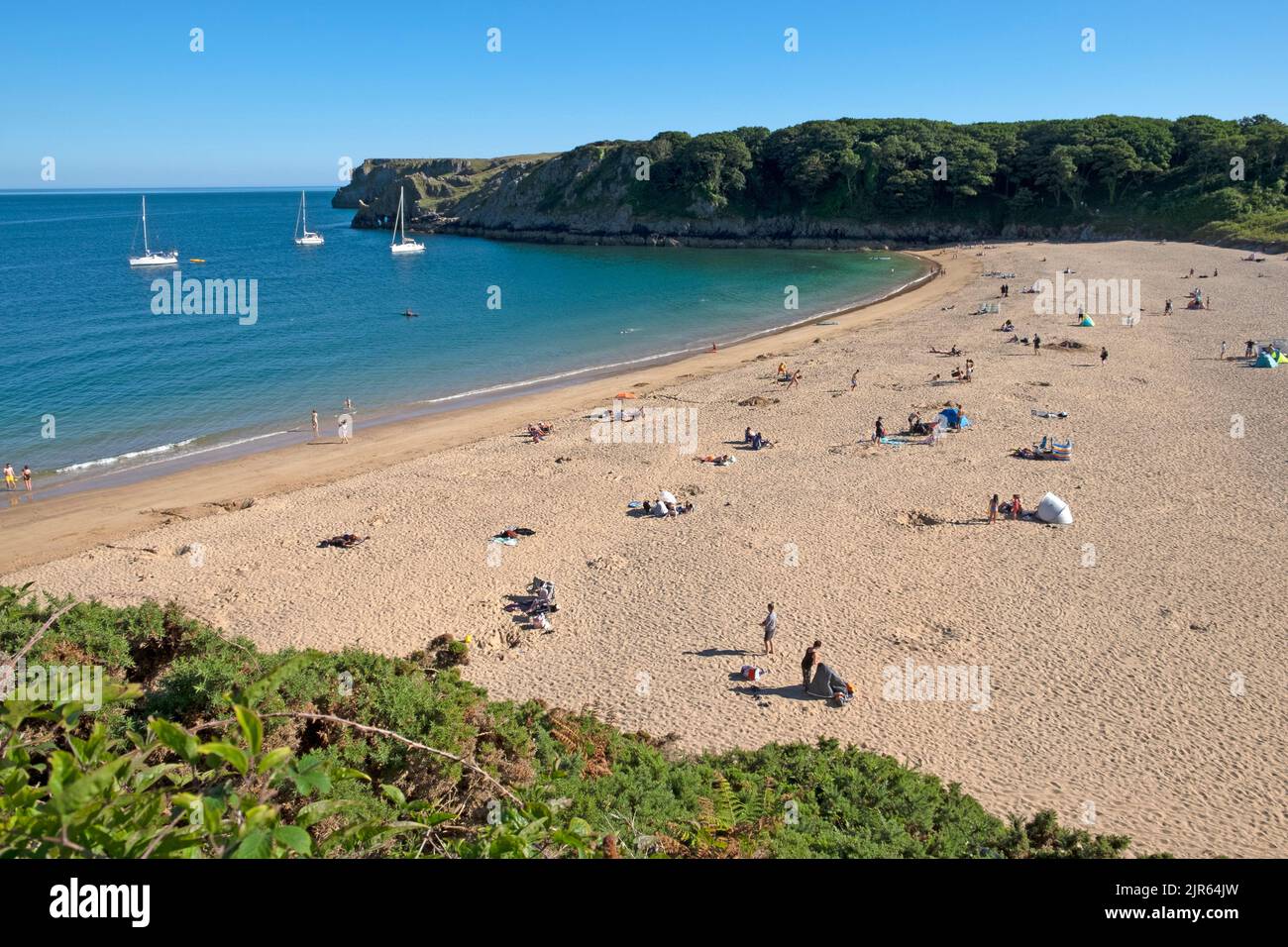 People holiday makers bathers relaxing on the sandy beach in summer at ...