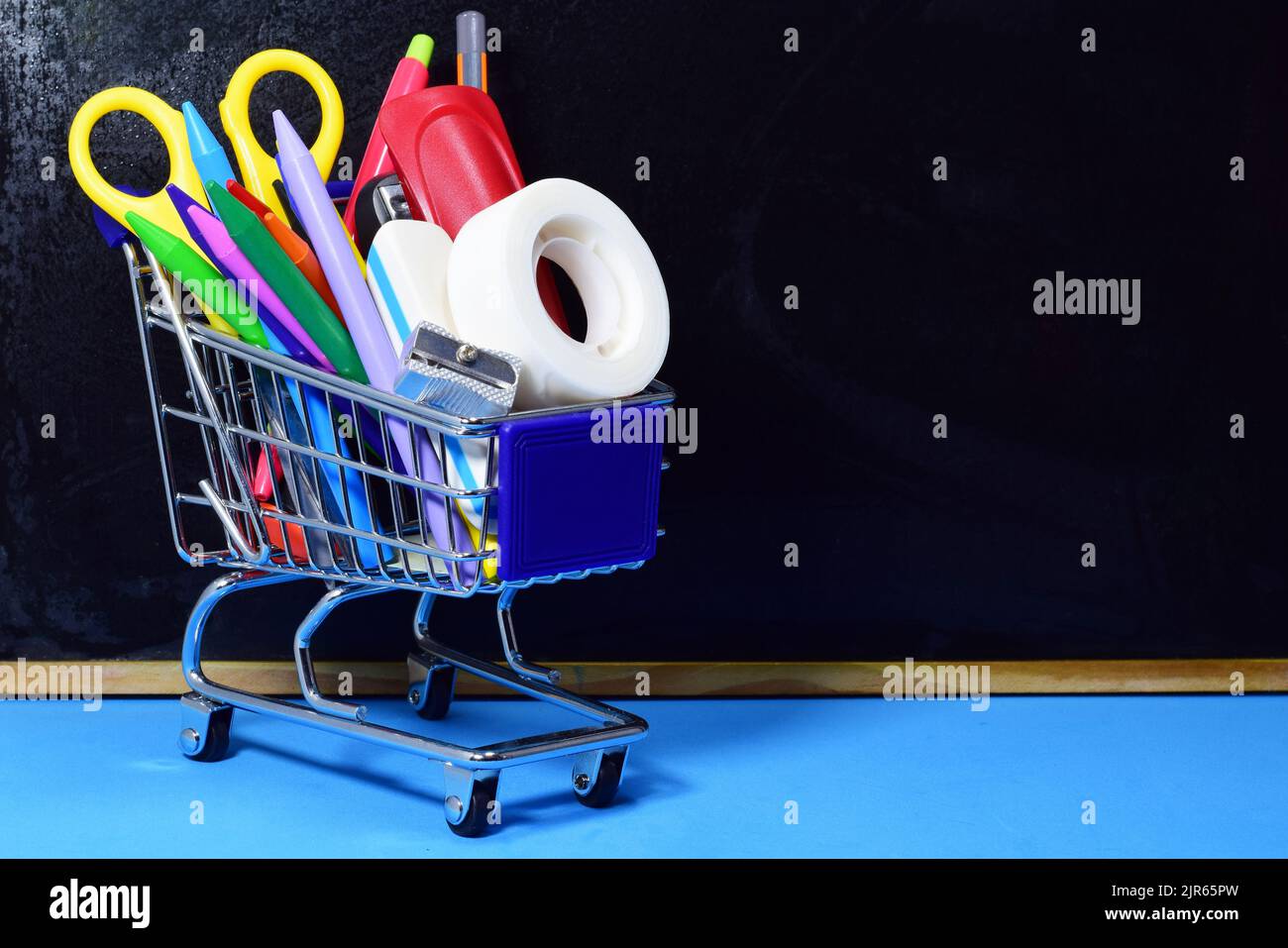 An assorted school supplies scattered on the blue background Stock ...
