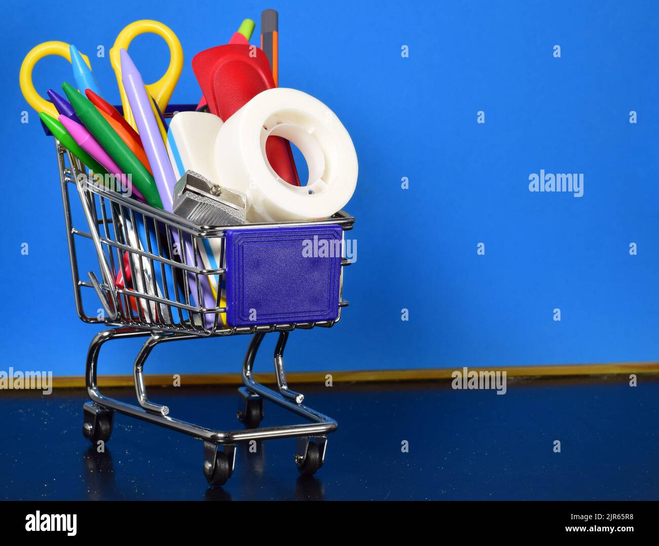 An assorted school supplies scattered on the blue background Stock ...