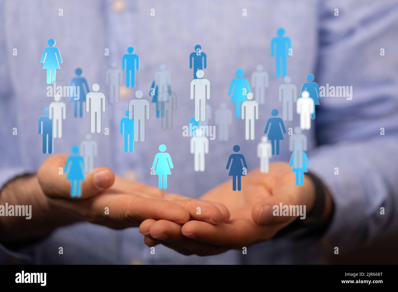 A 3D rendering of a group of floating people icons on a businessman's ...