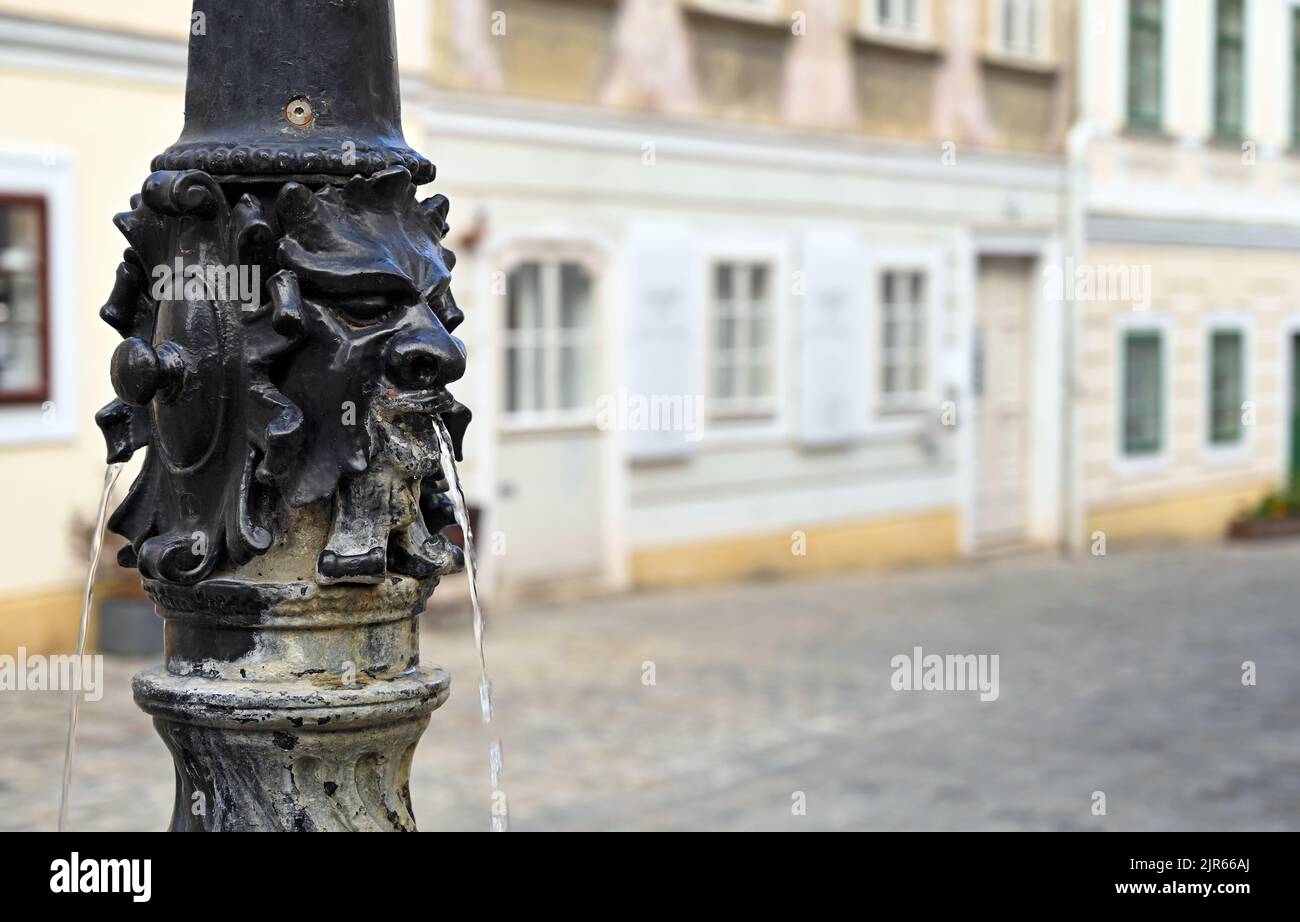 a small fountain with a human face in Vienna Stock Photo - Alamy