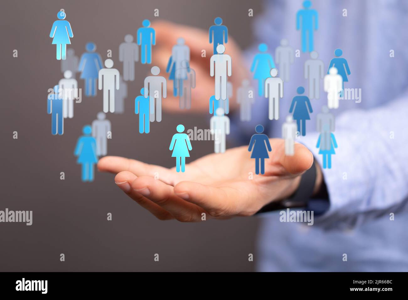 A 3D rendering of a group of floating people icons on a businessman's ...