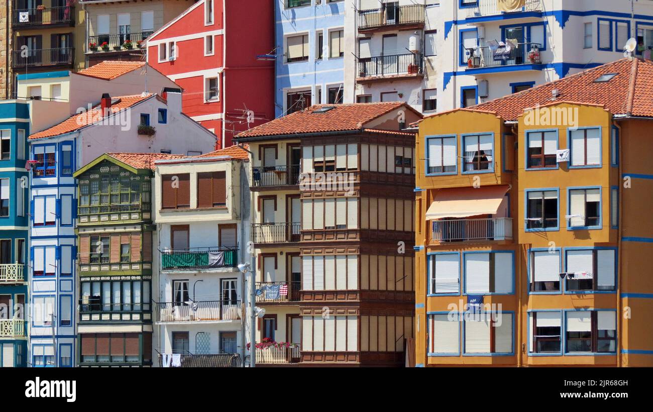 Colorful residential buildings in yellow blue red with sunlight on the ...