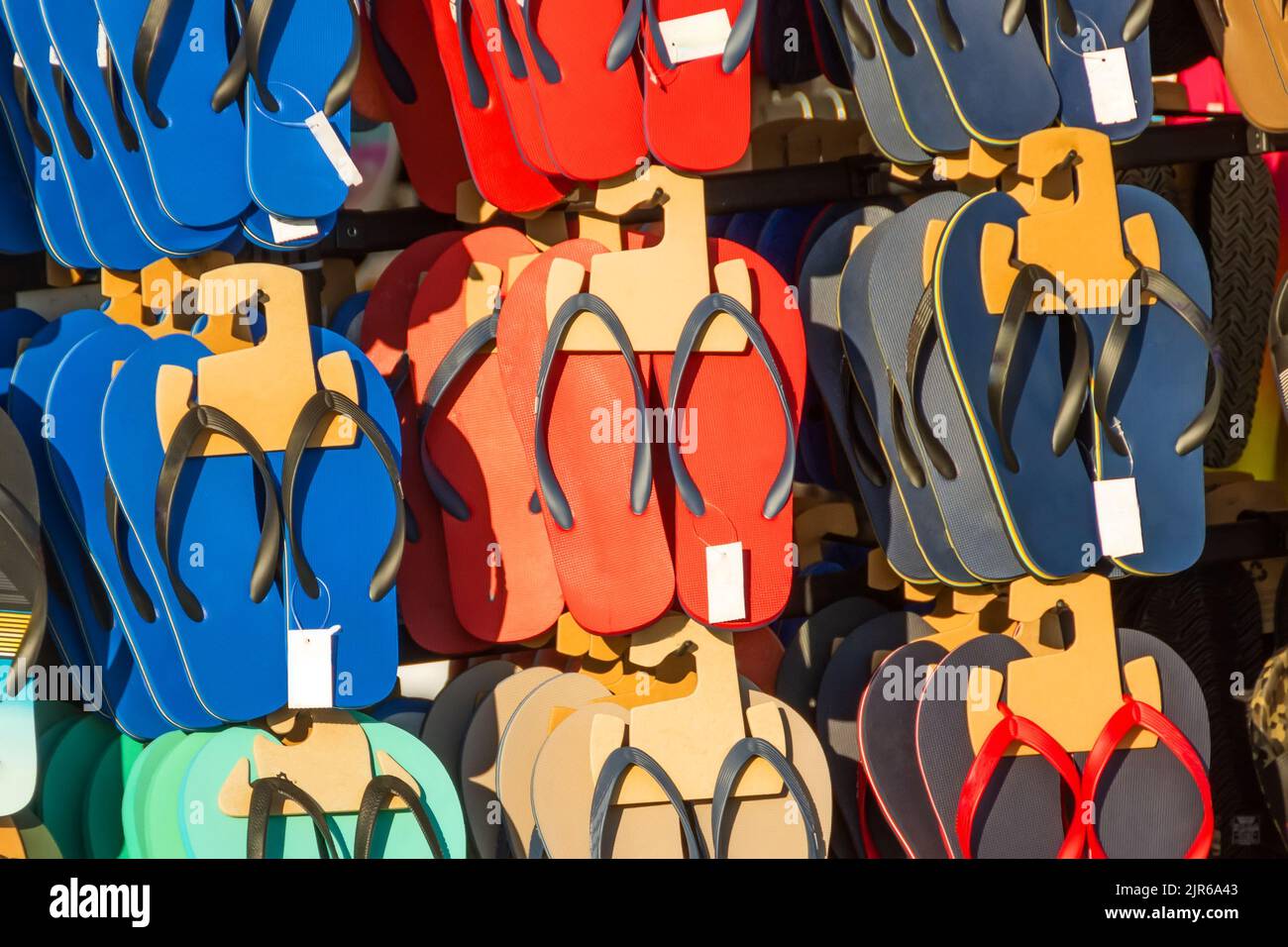 Showcase with blue, red and other colors of beach flip-flops in a shoe ...