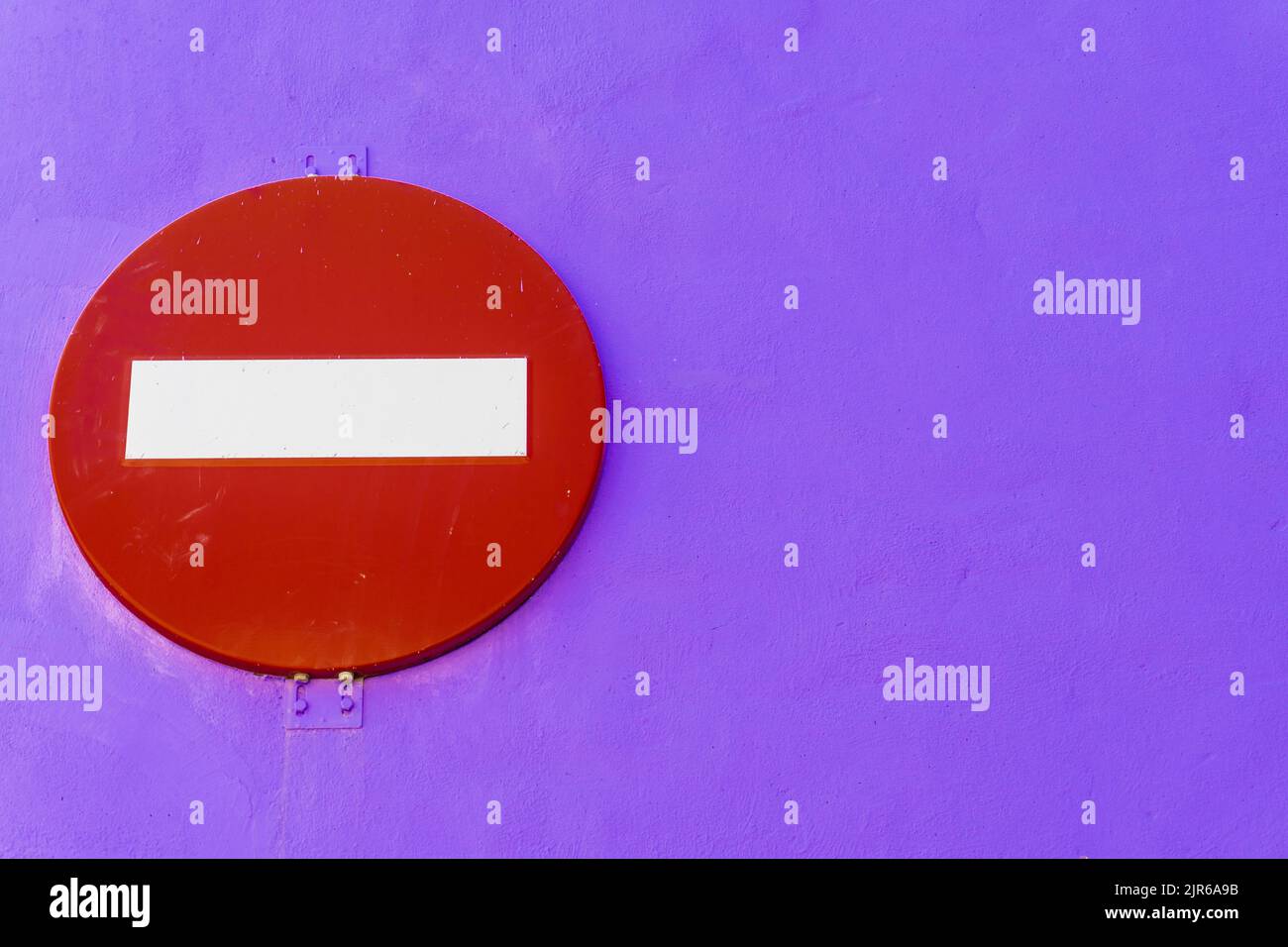A red sign of no entry on purple surface with copy space Stock Photo ...