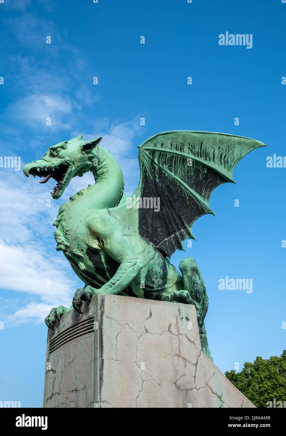 Isolated against wispy clouds and blue sky, the Dragon statue stands ...