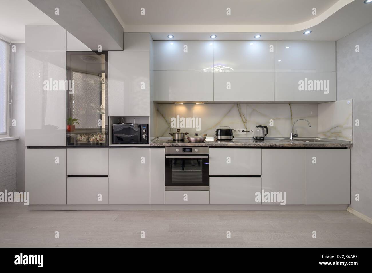 Interior of modern trendy white kitchen, front view Stock Photo - Alamy