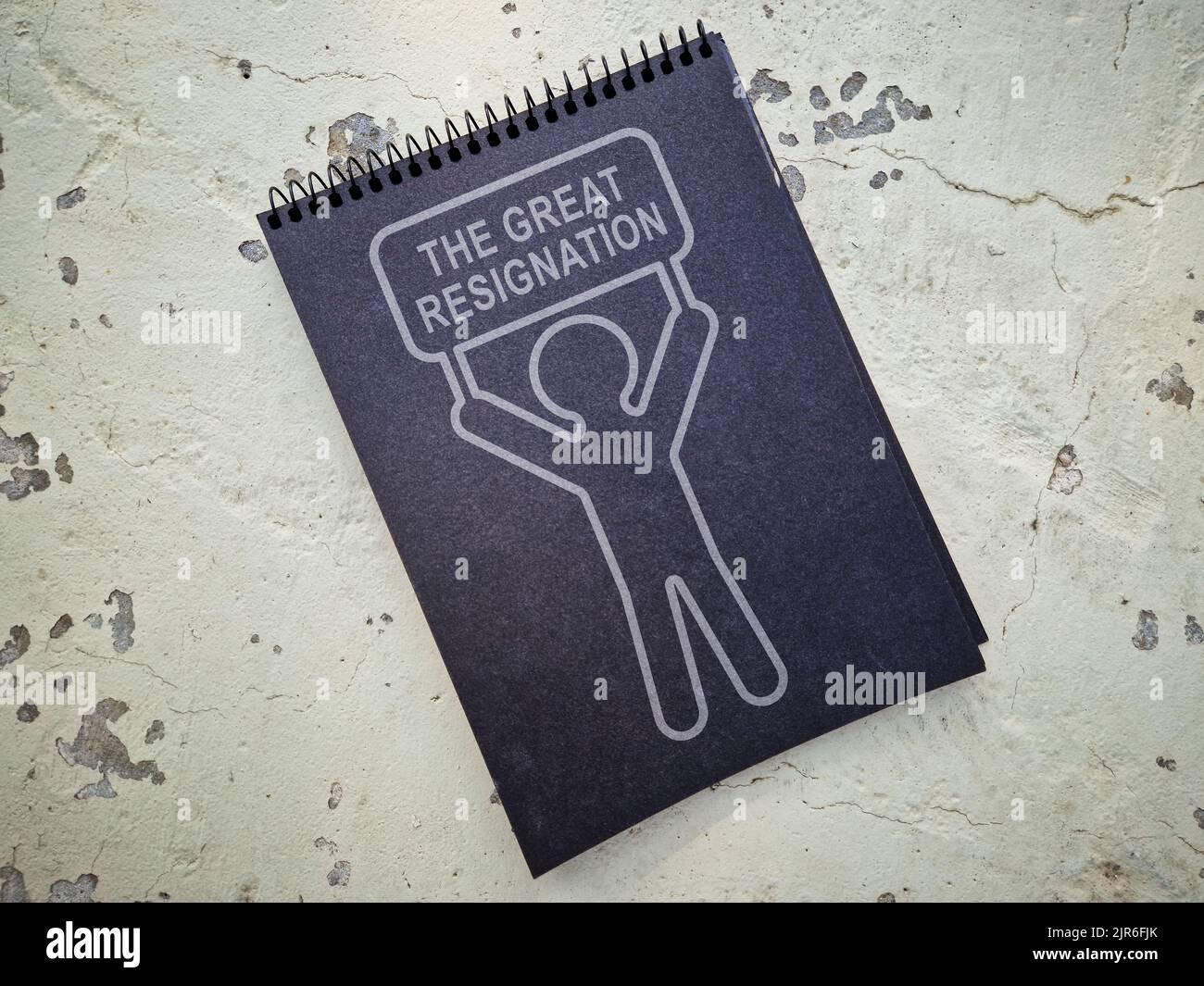 Notepad and figure with sign the great resignation Stock Photo - Alamy