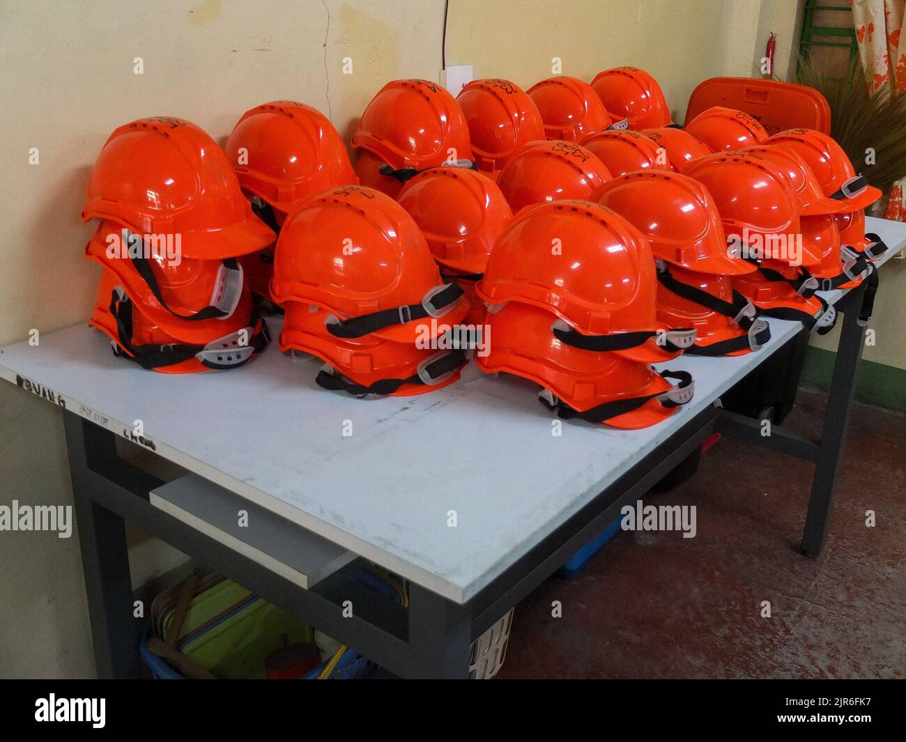 A table of safety helmets are on standby to protect students from ...