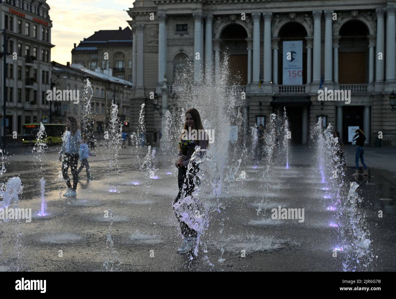 LVIV, UKRAINE - AUGUST 1, 2022 - A woman poses in the dry fountain ...