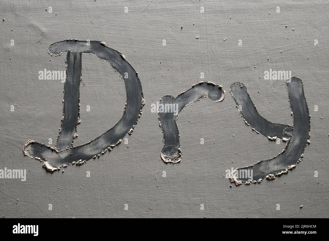 The word 'dry' scrawled by finger in dust surface Stock Photo - Alamy