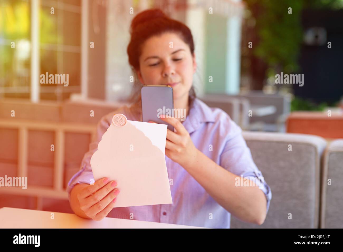 Closeup photography of woman,making photography of invitation envelope ...