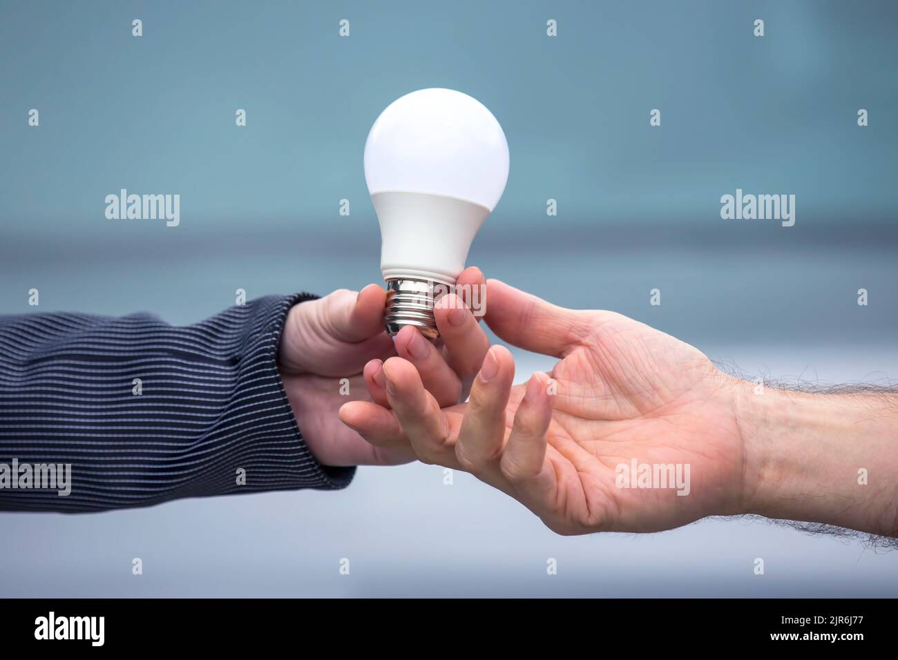 LED lamp in hand. Lighting with an electric object Stock Photo - Alamy