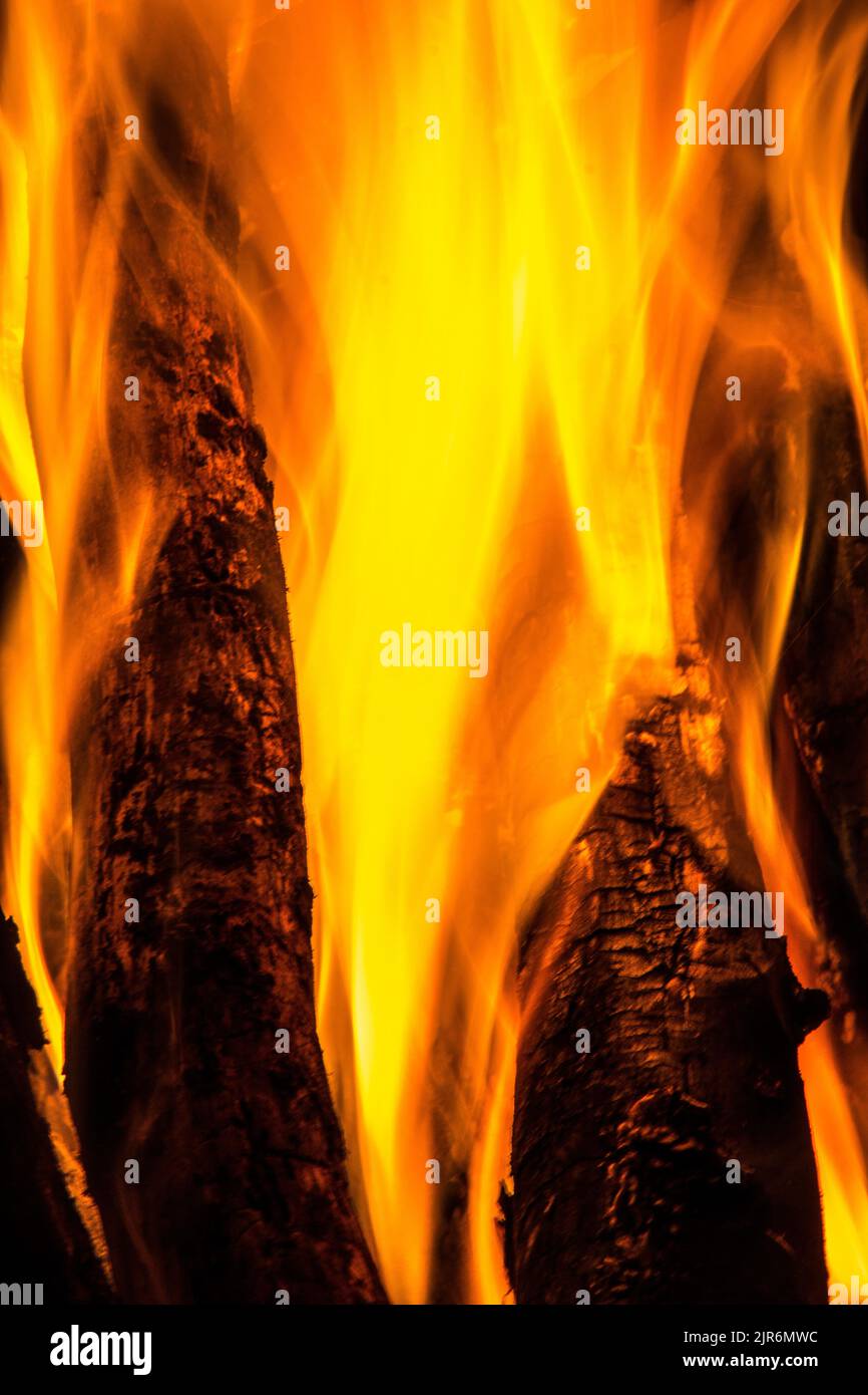 A vertical closeup shot of a abstract burning bonfire with dark ...