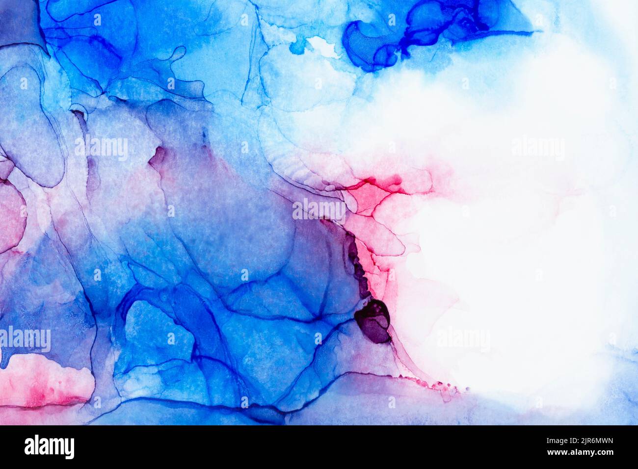 Macro close-up of blue and red alcohol ink layers & splashes, abstract ...