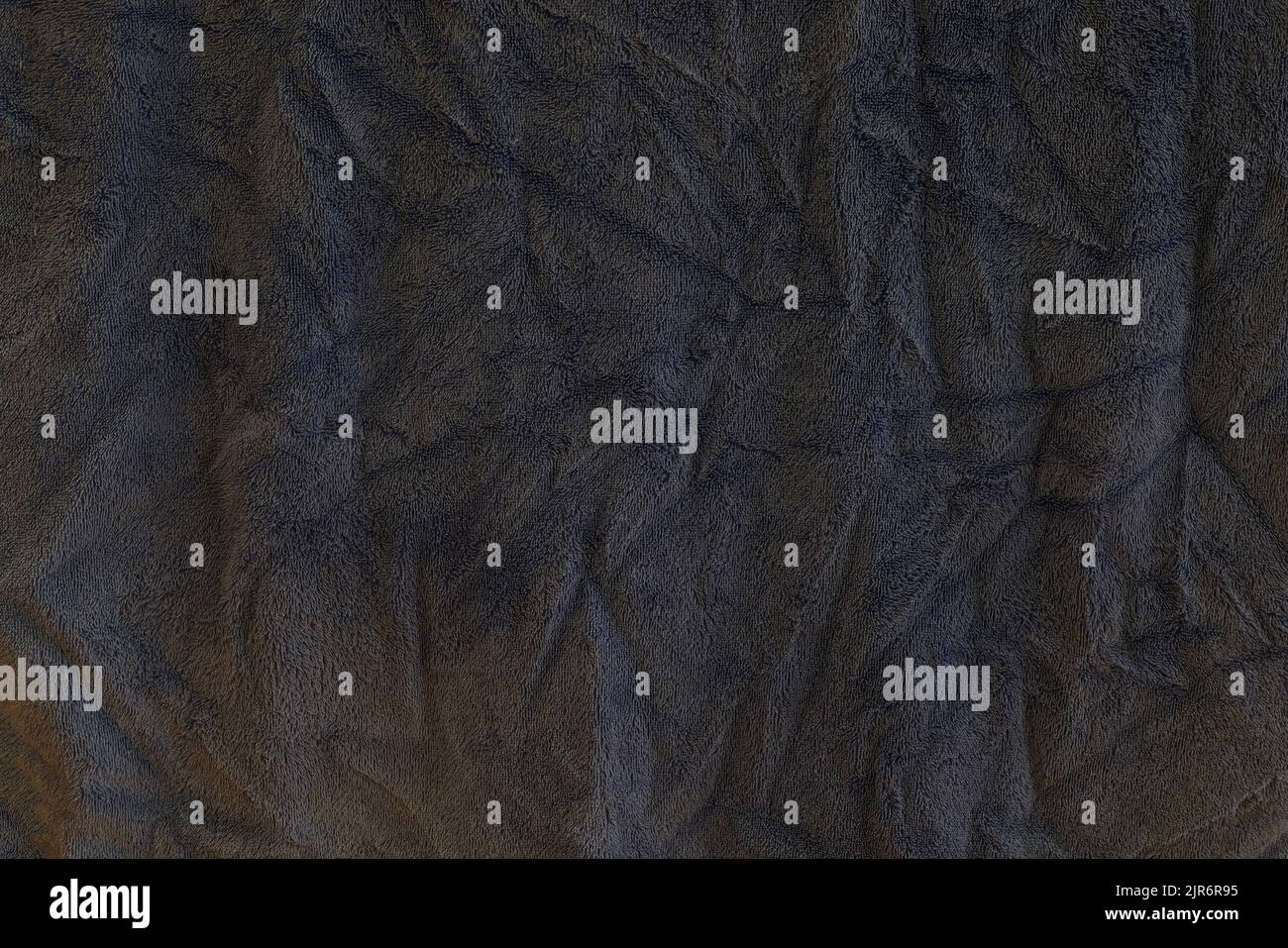 Close up background of texture of dark blue bath towel filling the ...