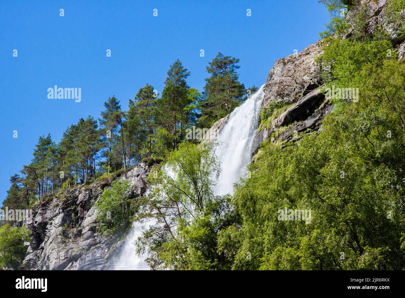 View of Tvindefossen or Tvinnefossen waterfall near Voss in Norway ...