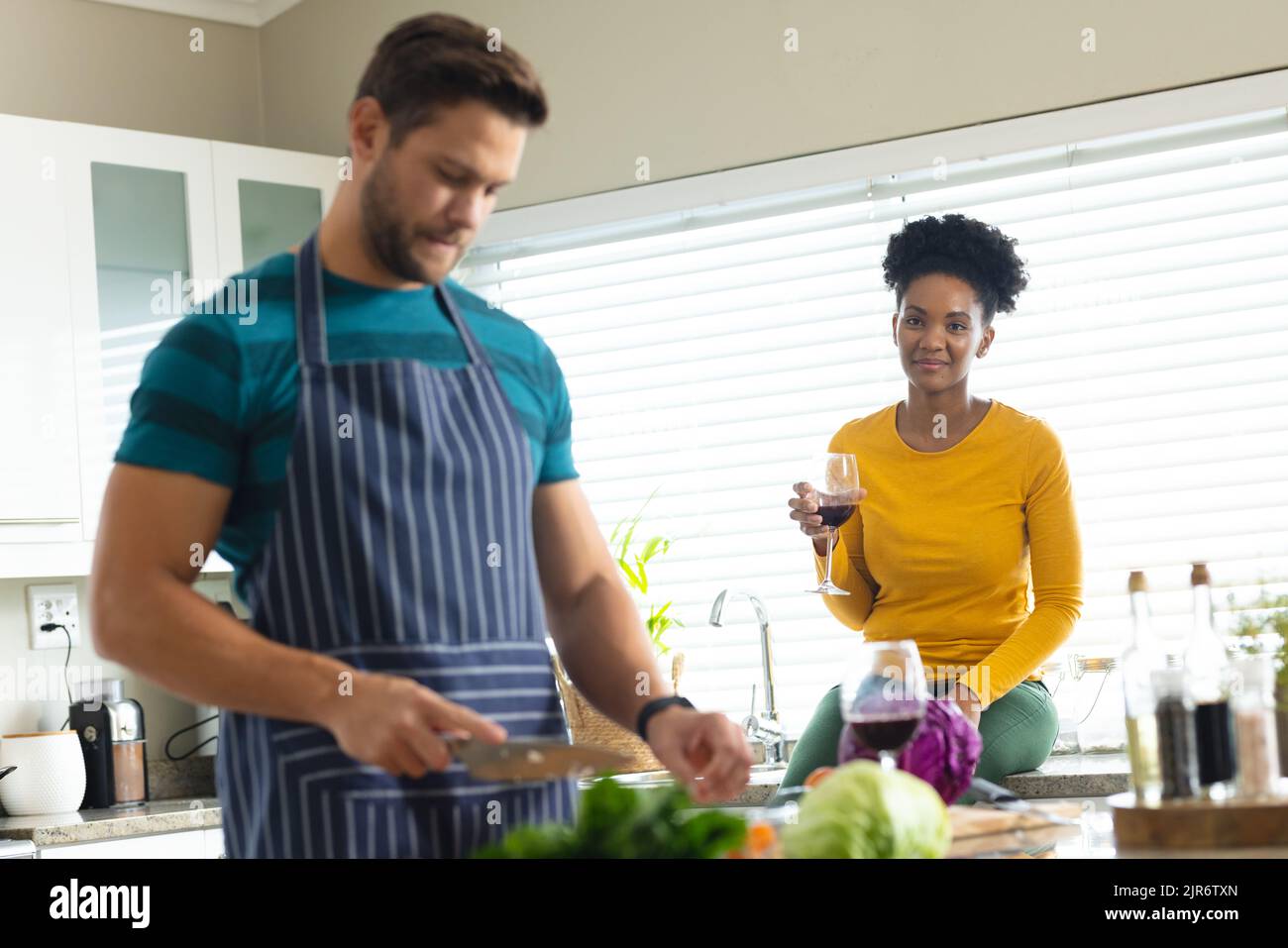Image of diverse couple preparing meal together in kitchen Stock Photo ...