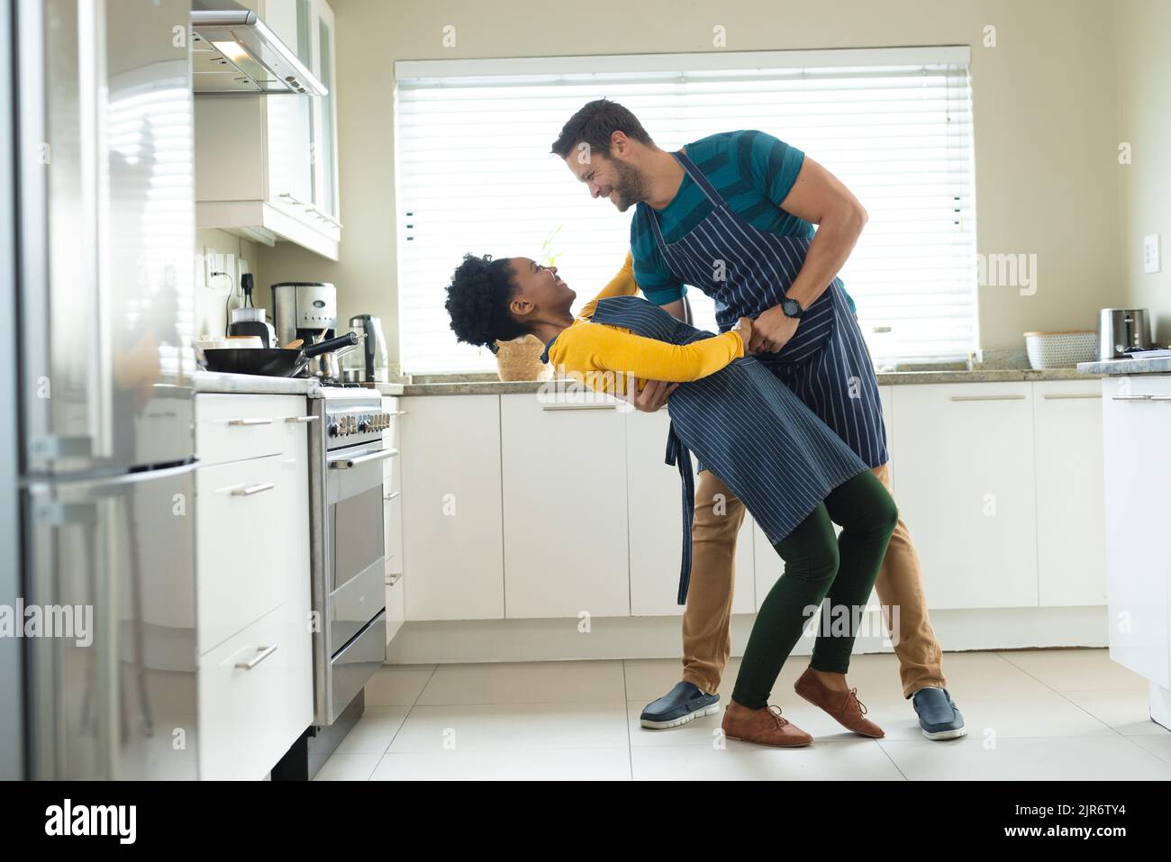 Image of happy diverse couple dancing in kitchen Stock Photo - Alamy