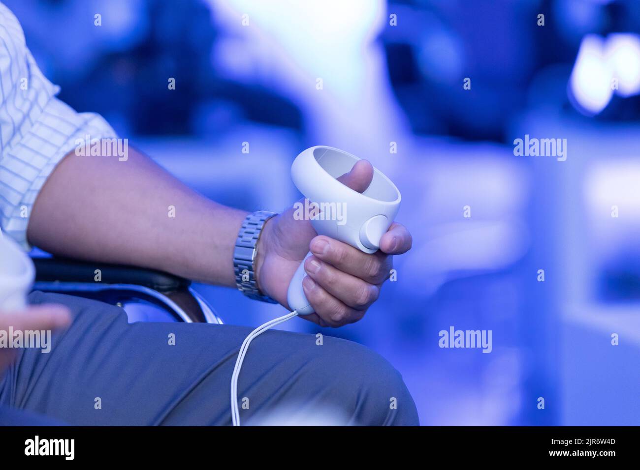 A closeup of male hands playing with virtual reality controllers ...