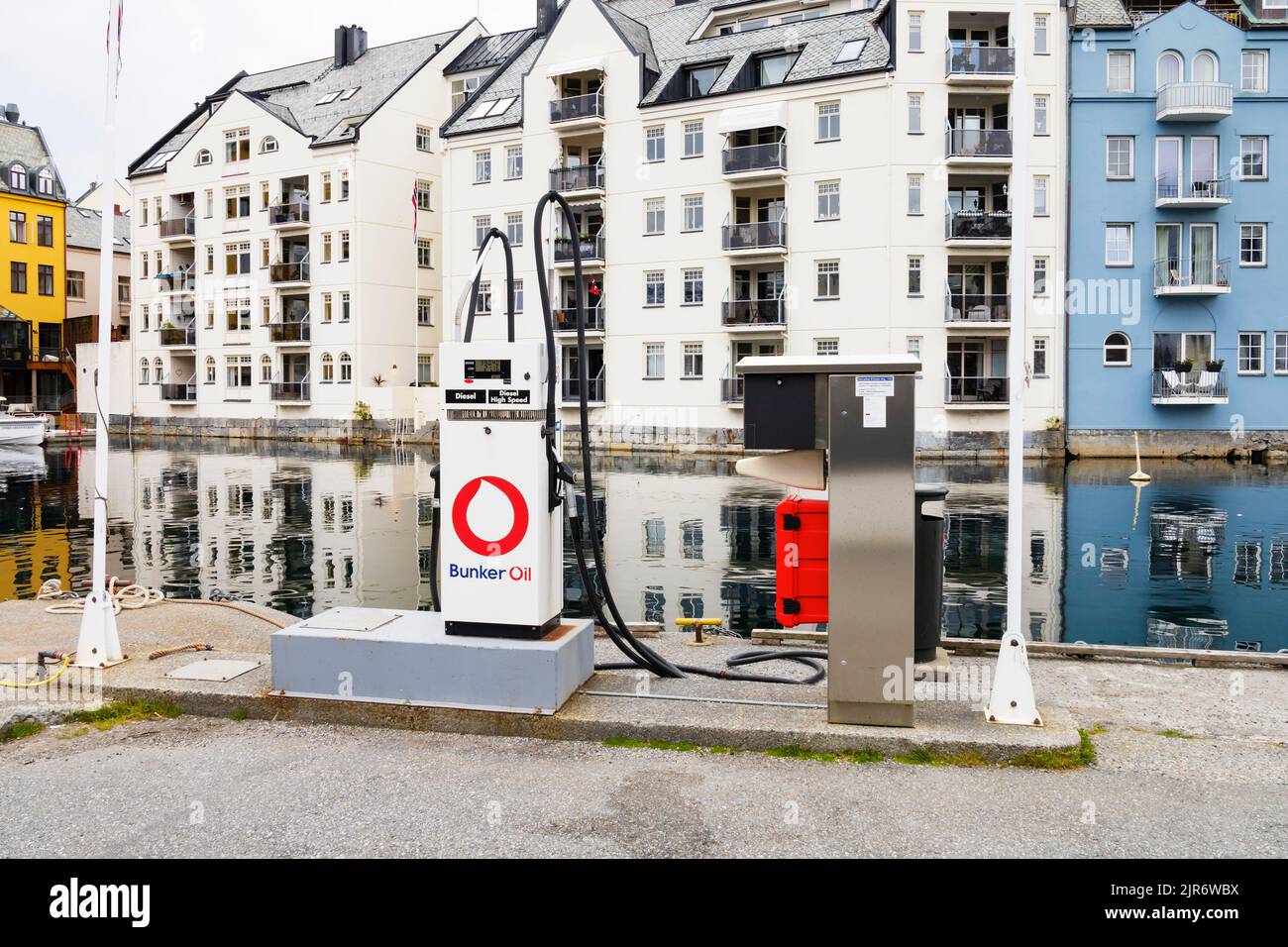 Marine bunker oil diesel fuel pump with House reflections in the water ...