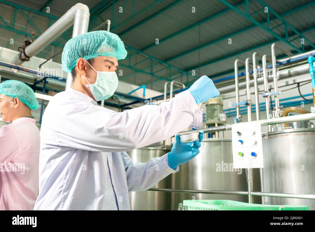 Engineer working at Fruit juice Bottle Automated conveyor belt ...