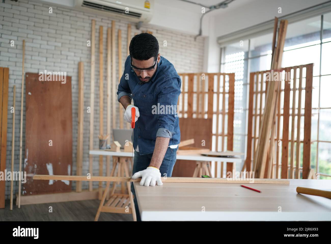 Carpenter grinding joinery product with carvings, finishing woodwork at ...