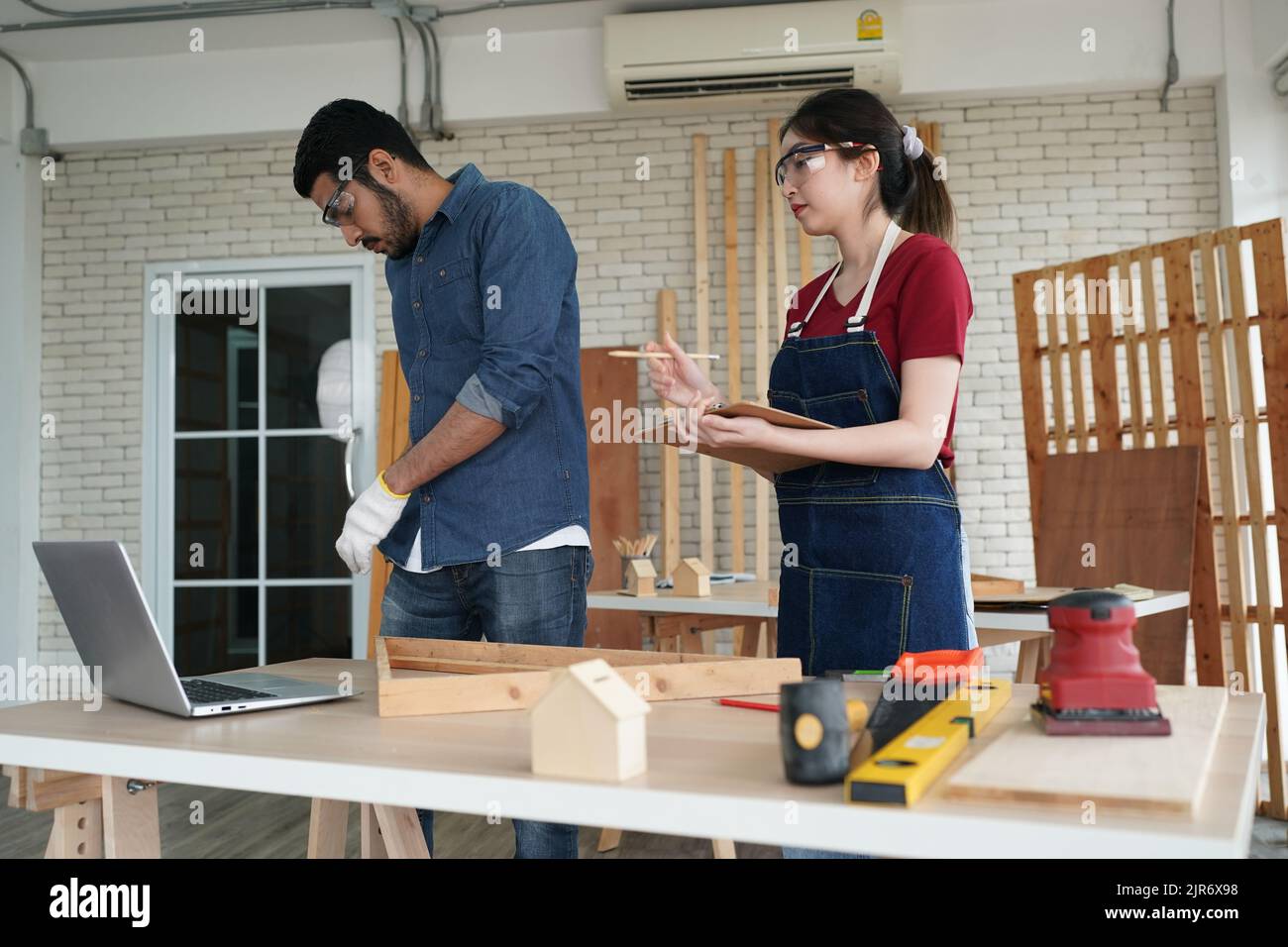 Carpenter grinding joinery product with carvings, finishing woodwork at ...