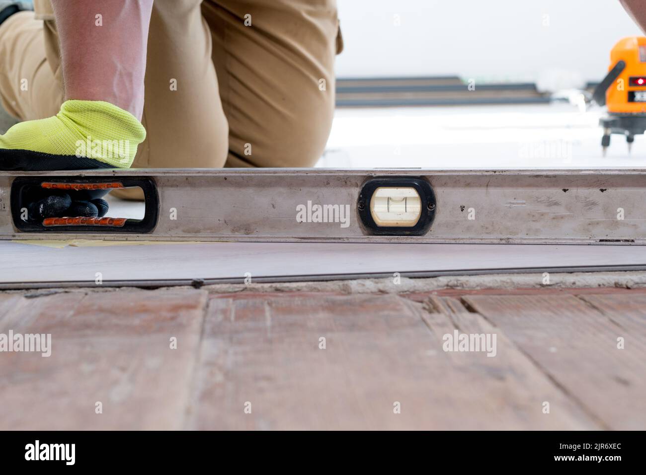 The master measures the level of the floor surface Stock Photo - Alamy