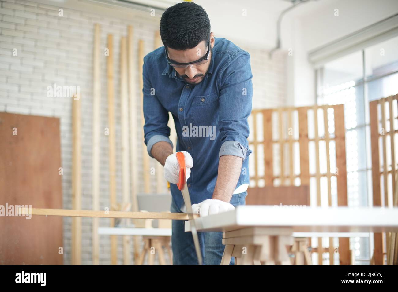 Carpenter grinding joinery product with carvings, finishing woodwork at ...