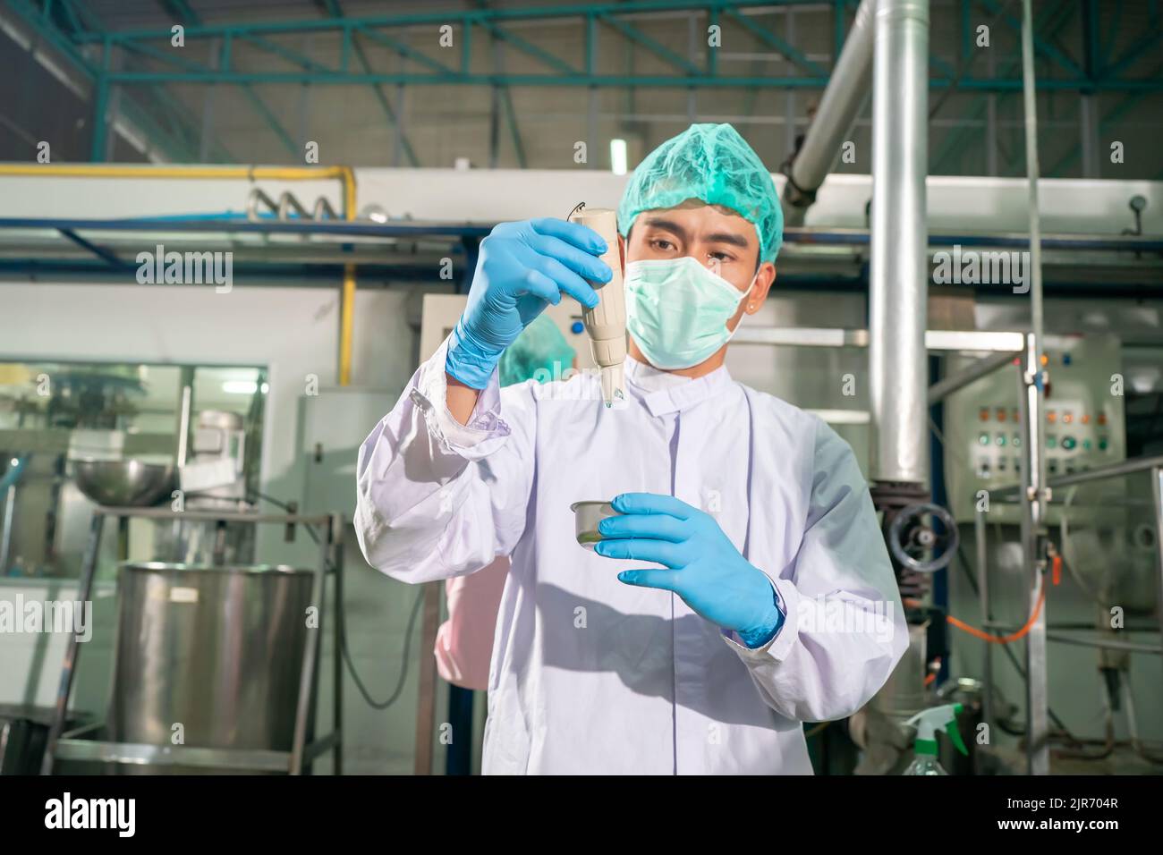 Engineer working at Fruit juice Bottle Automated conveyor belt ...