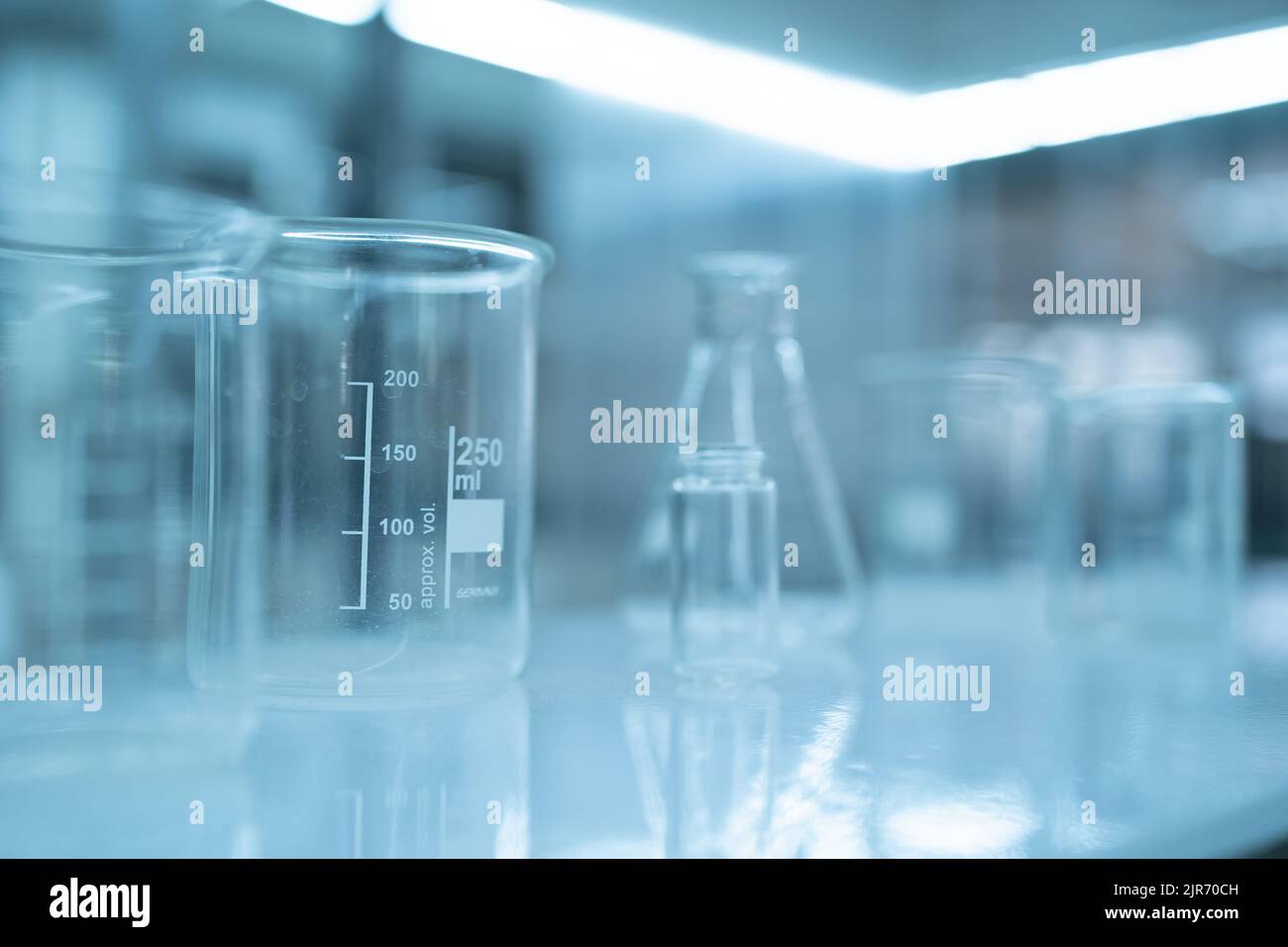 scientist doing research on plants holding a green solution in a test ...