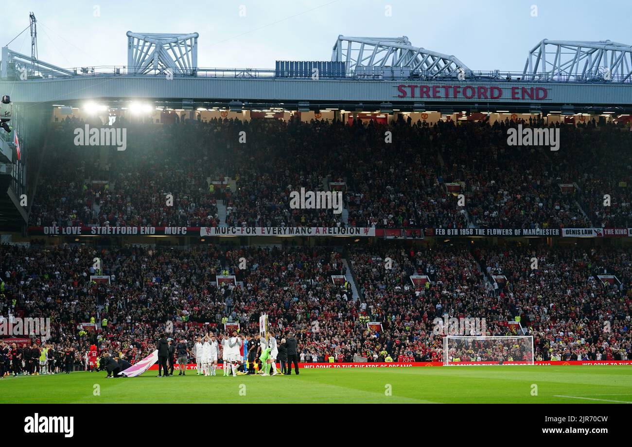 The players line up in view of the Stretford End stand before the ...