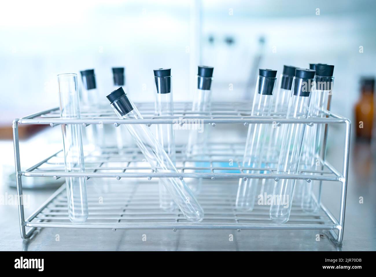 scientist doing research on plants holding a green solution in a test ...