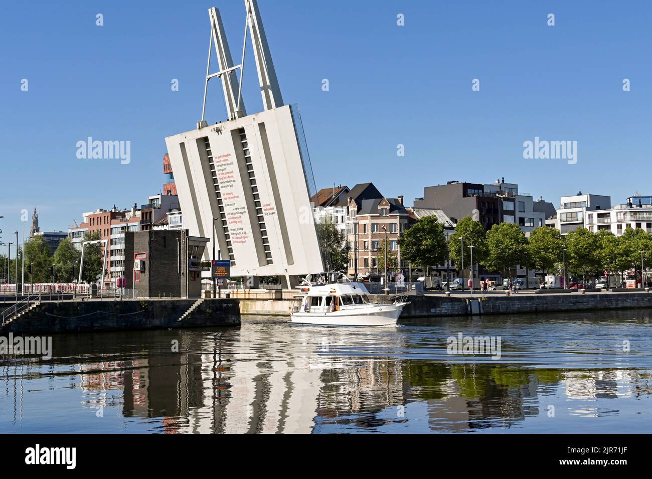 Antwerp, Belgium - August 2022: Small motor boat sailing pas a lifting ...