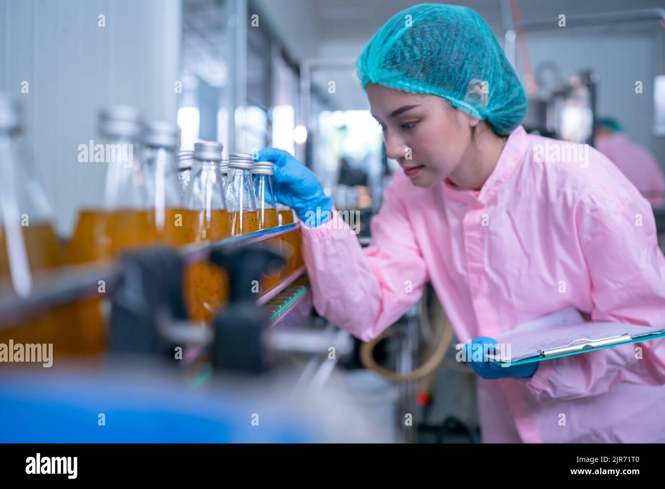 Engineer working at Fruit juice Bottle Automated conveyor belt ...