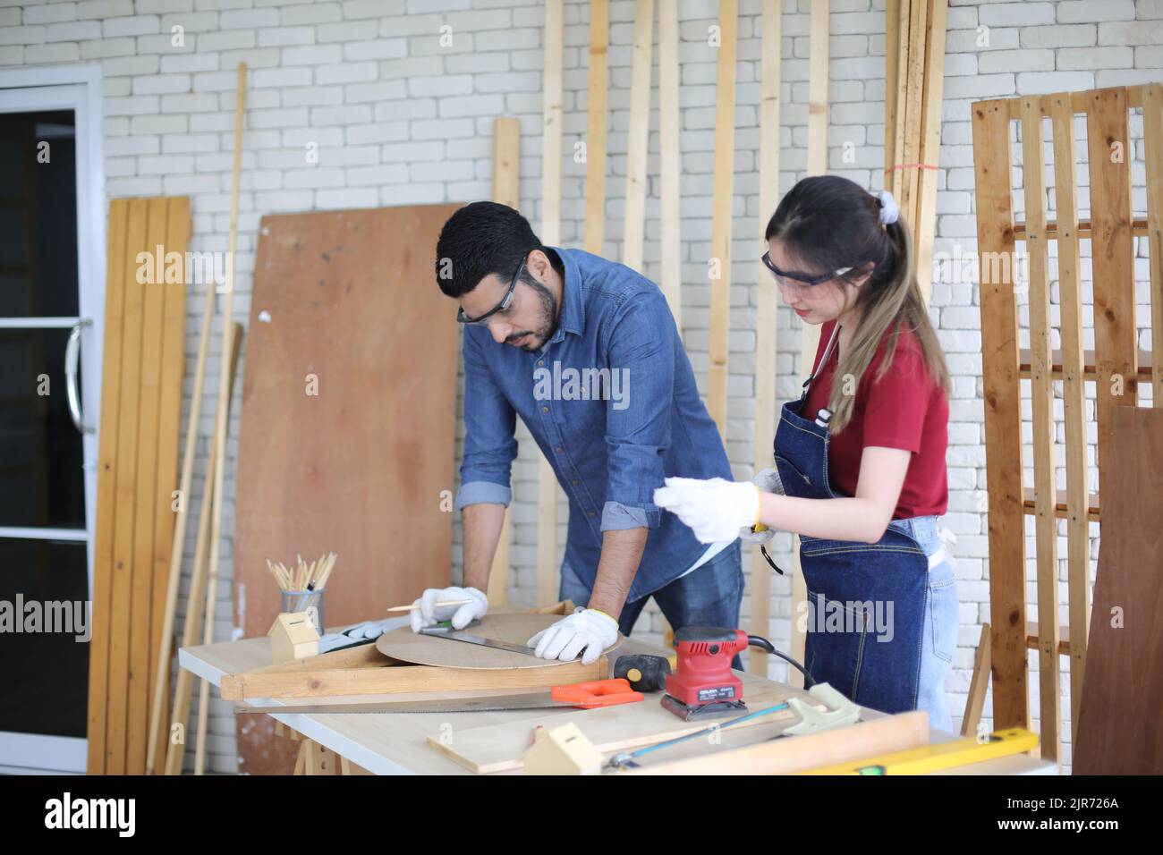Carpenter grinding joinery product with carvings, finishing woodwork at ...