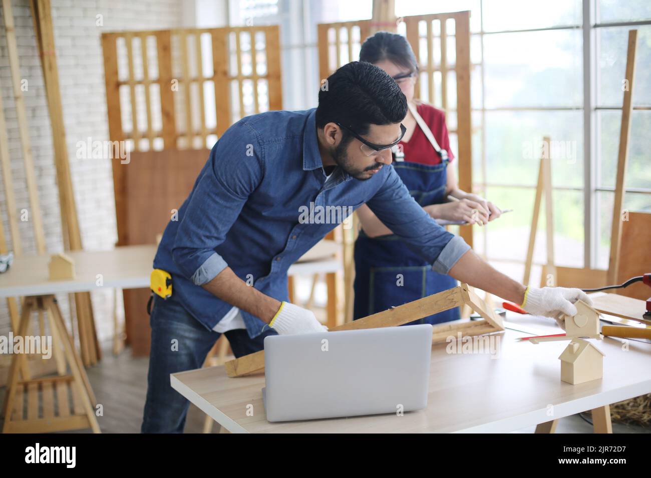 Carpenter grinding joinery product with carvings, finishing woodwork at ...
