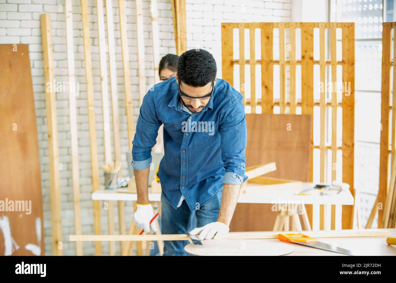 Carpenter grinding joinery product with carvings, finishing woodwork at ...
