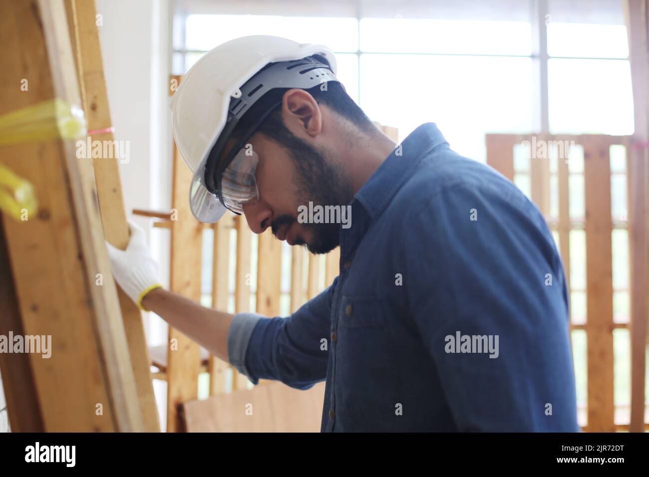 Carpenter grinding joinery product with carvings, finishing woodwork at ...